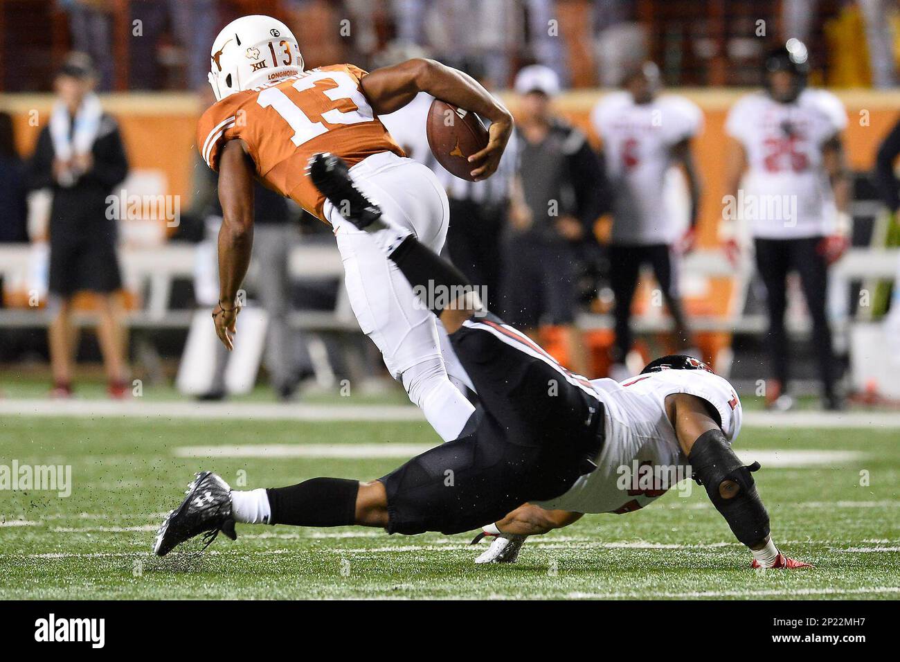 Texas quarterback Jerrod Heard (13) rushes past a diving Texas Tech's ...