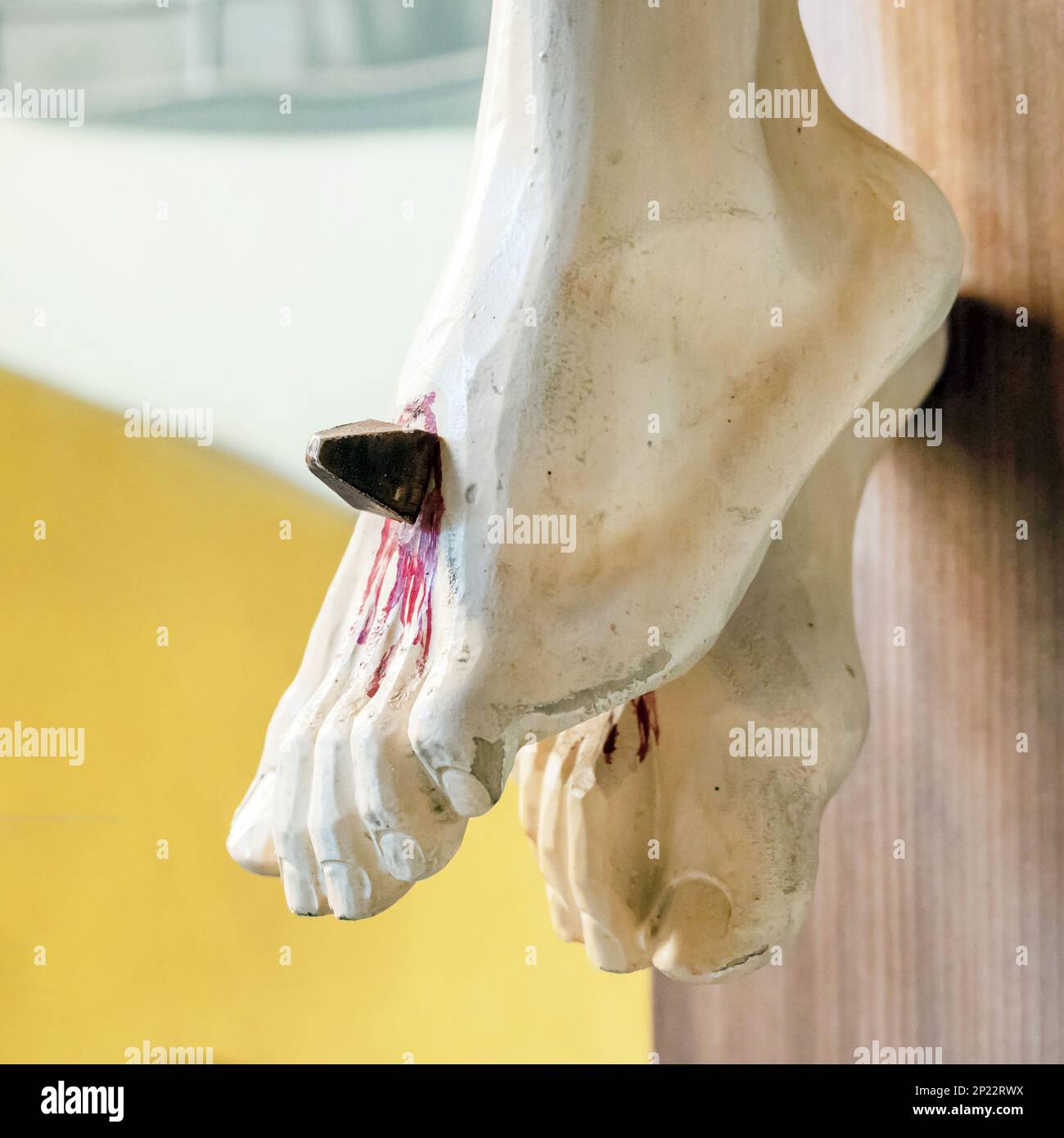 Nailed feet, detail of wooden statue of Jesus Christ crucified in a defocused background Stock ...