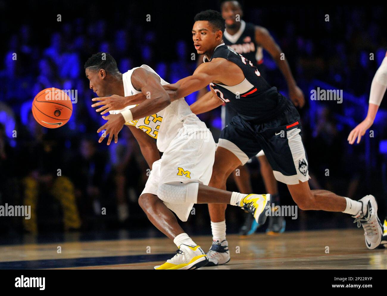 Connecticut forward Shonn Miller (32) pokes the ball away from Michigan ...