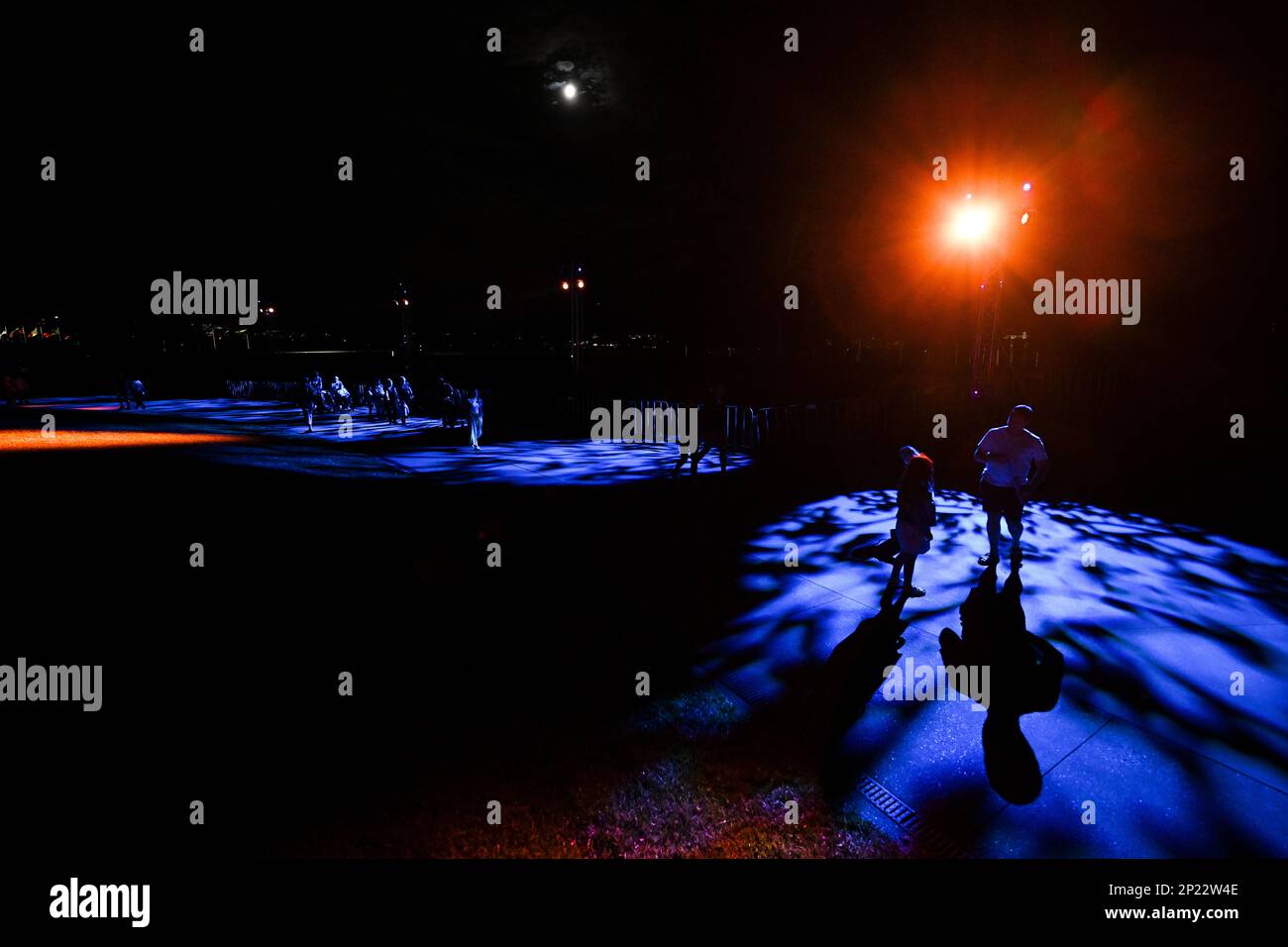 Visitors walk between light shows, projected onto the National Portrait ...
