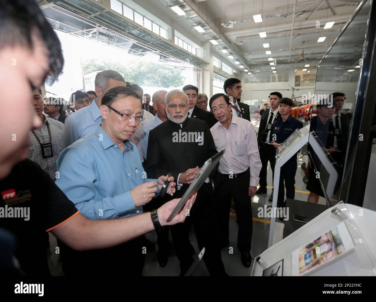 School principal Ang Kiam Wee, second from left, shows Indian Prime ...