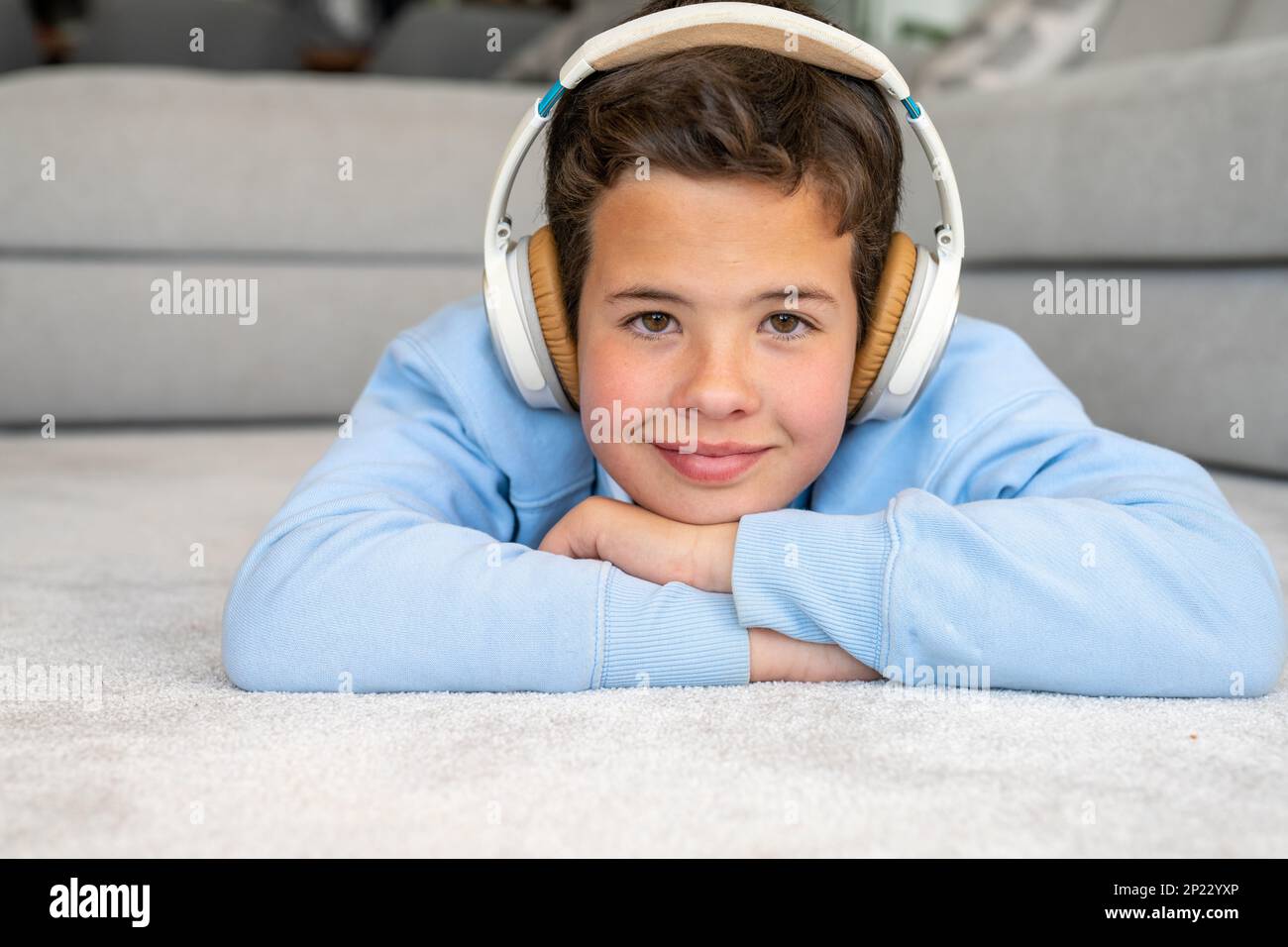 Child wearing headphones listens to music. Cute boy listening to music ...