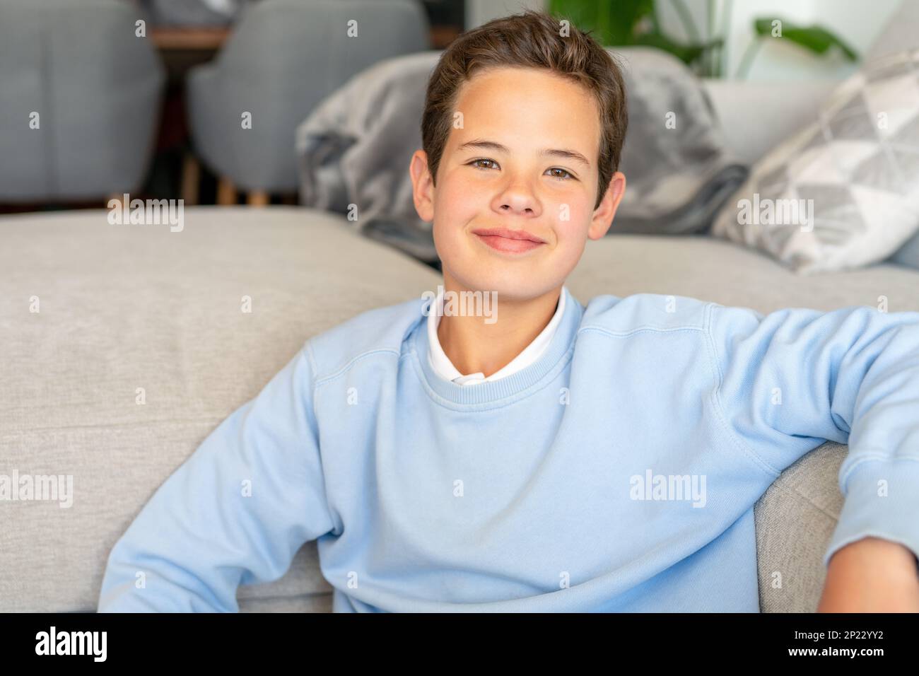 Male school kid, schoolchild, young guy with neck-length brown hair ...