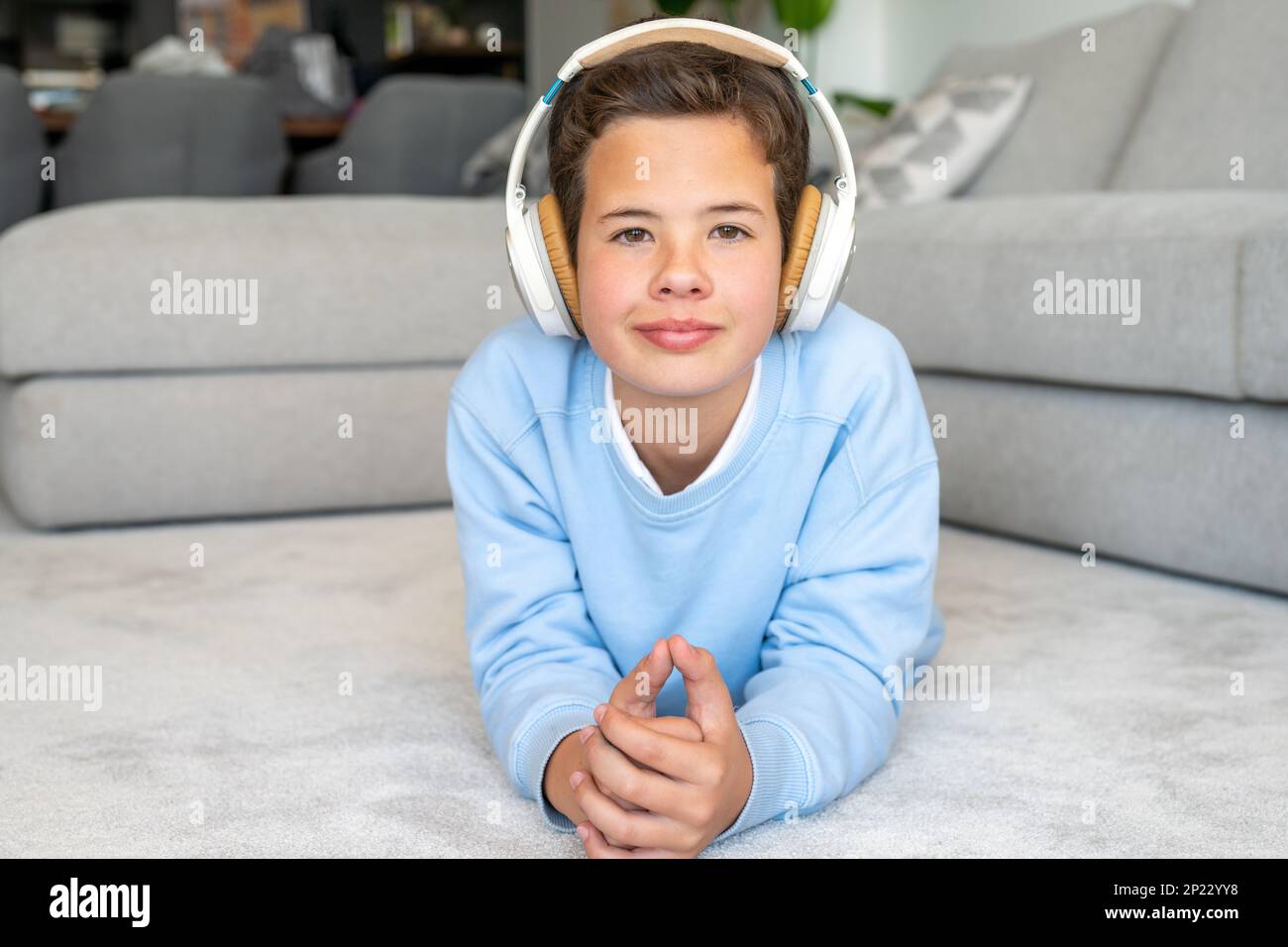 Child wearing headphones listens to music. Cute boy listening to music ...