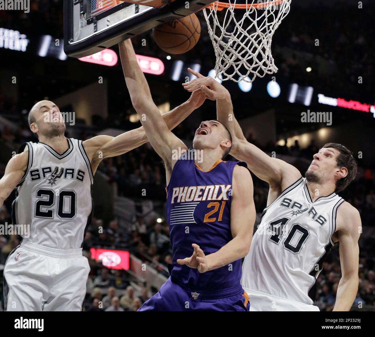 Phoenix Suns' Alex Len (21) is blocked by San Antonio Spurs' Manu ...