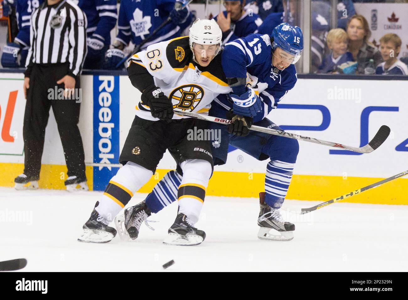 Boston Bruins Brad Marchand, left, tangles with Toronto Maple Leafs ...
