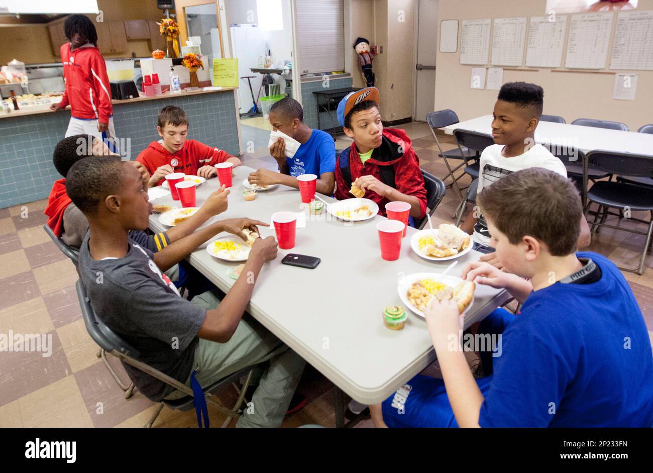 In this photo from Monday, Oct. 26, 2015, boys eat dinner at the ...