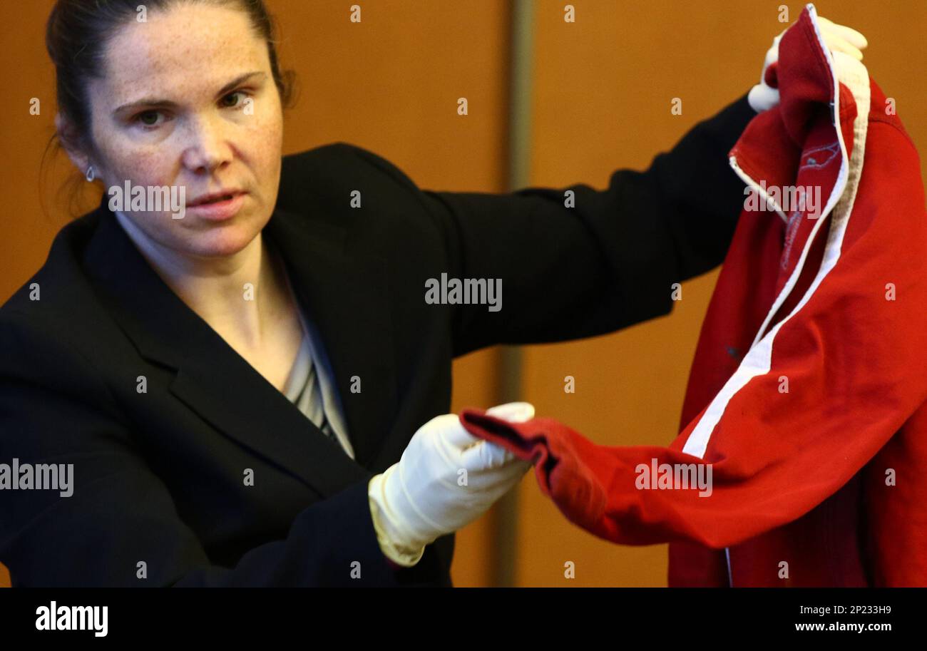 Abbey Scott a state police chemist shows blood stains on the this red ...