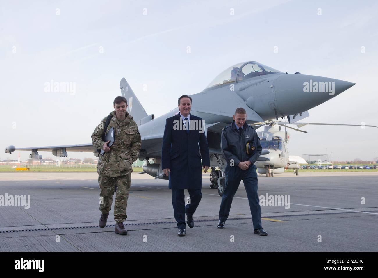 British Prime Minister David Cameron, centre, walks with Group Captain ...