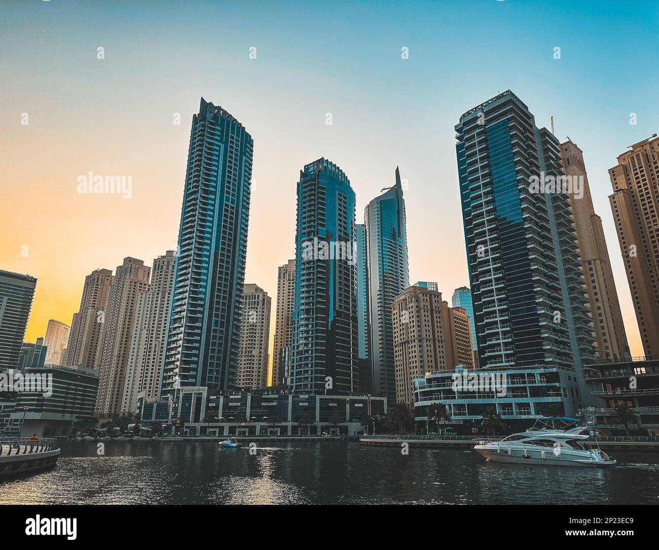 Dubai Marina, harbour, cruise boat and canal promenade view at sunset ...