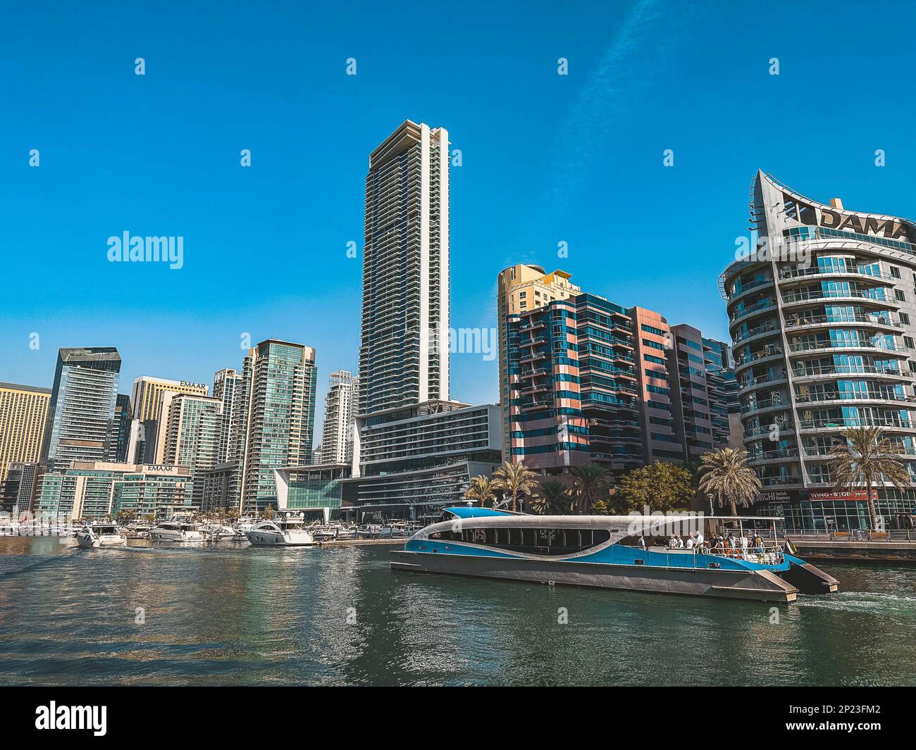 Dubai Marina, harbour, cruise boat and canal promenade view at sunset ...