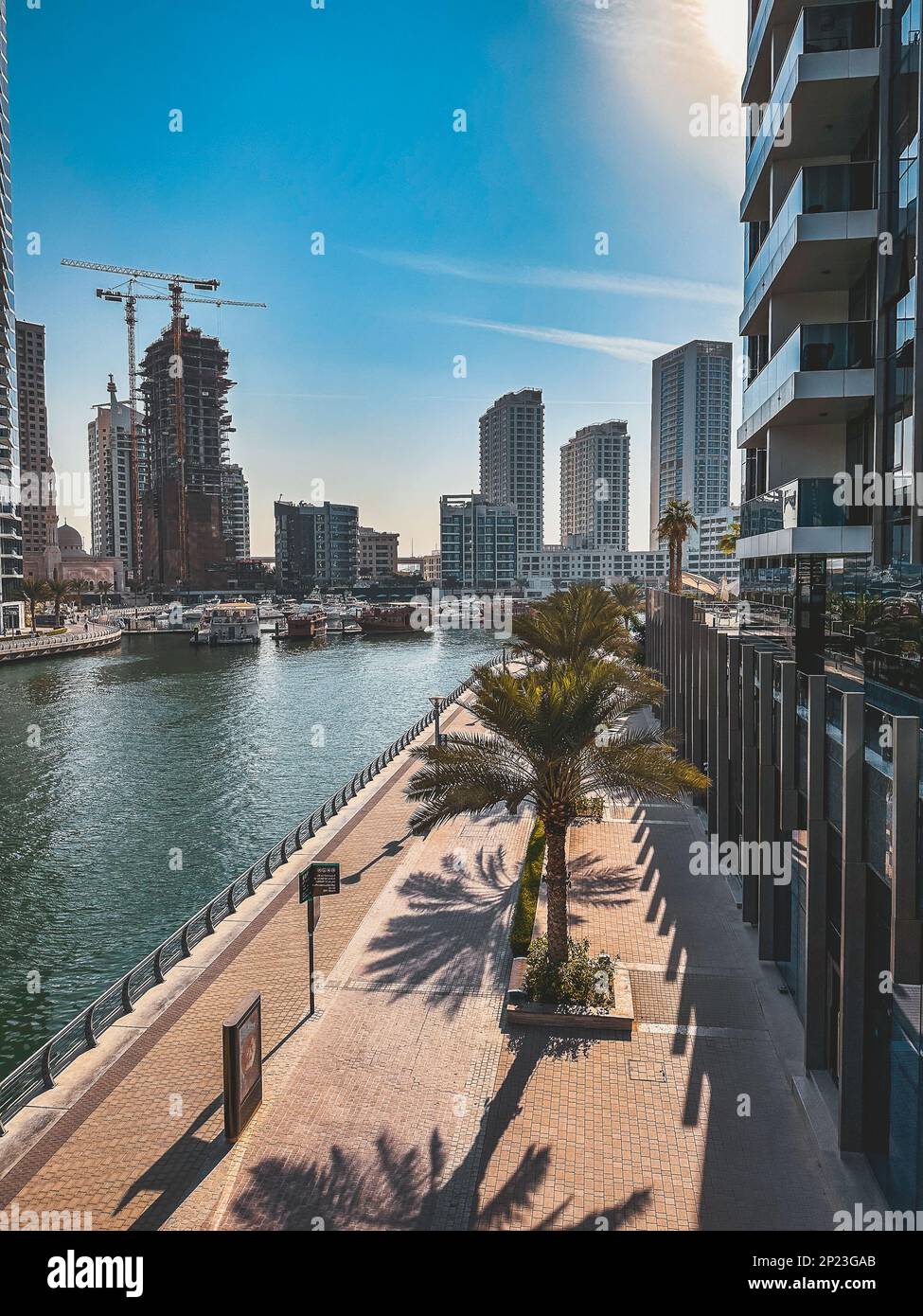 Dubai Marina, harbour, cruise boat and canal promenade view at sunset ...