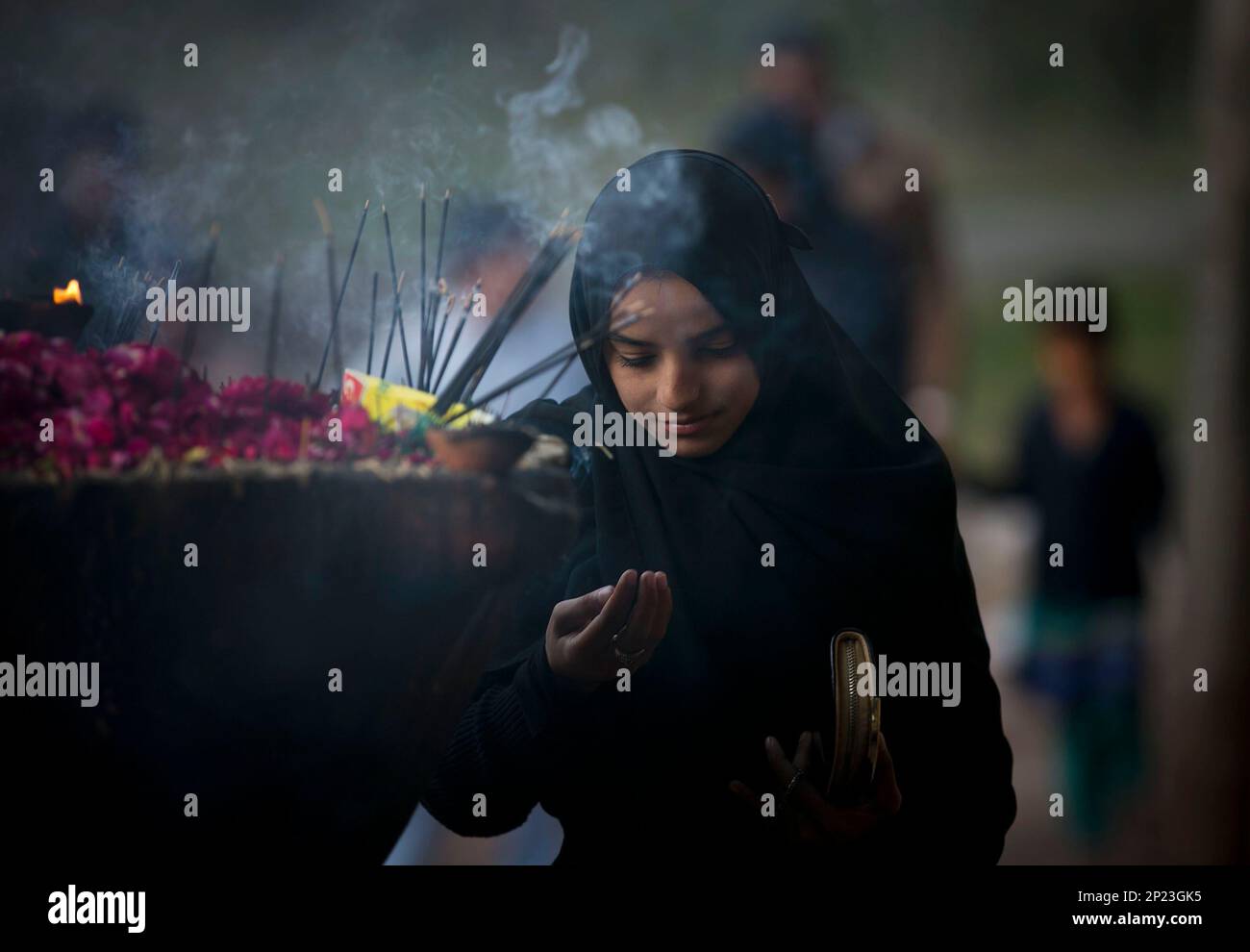 A Pakistani devotee prays at the shrine of Sufi Barri Imam to get her wishes fulfilled in ...