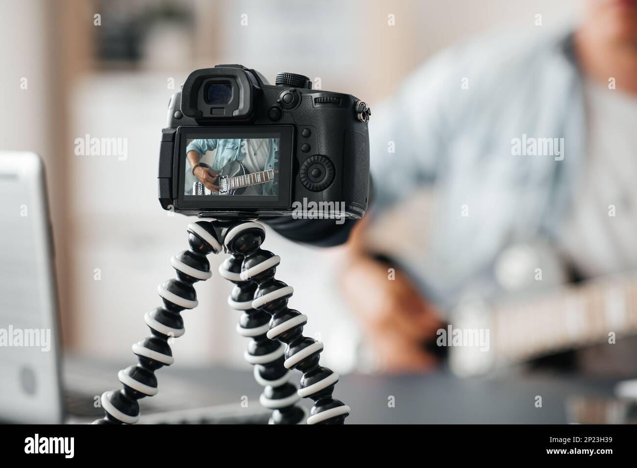 camera recording video of man playing guitar Stock Photo - Alamy