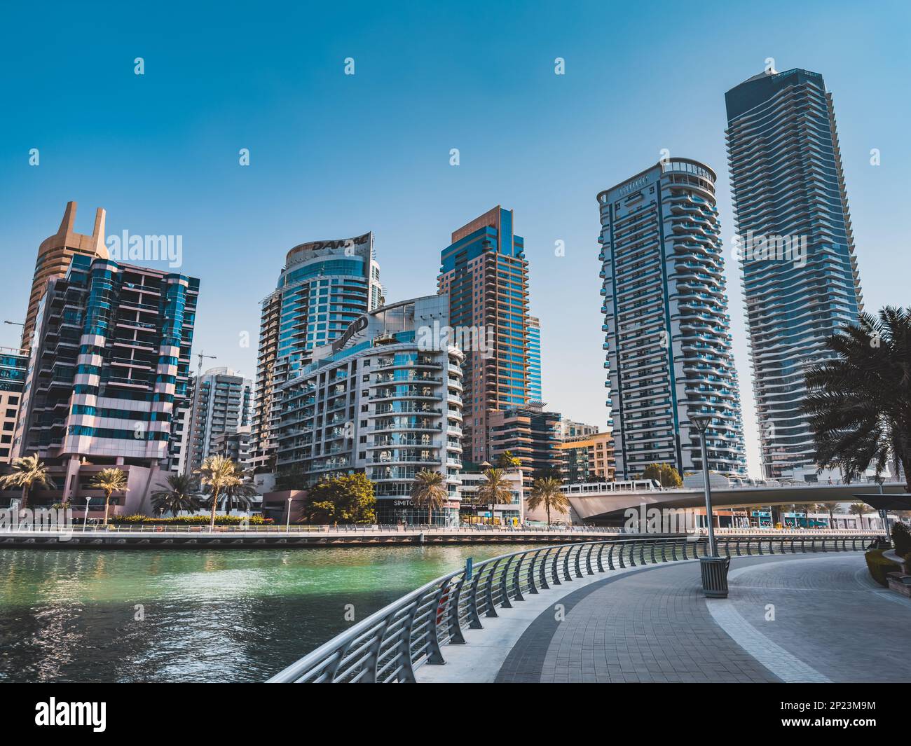 Dubai Marina, harbour, cruise boat and canal promenade view at sunset ...