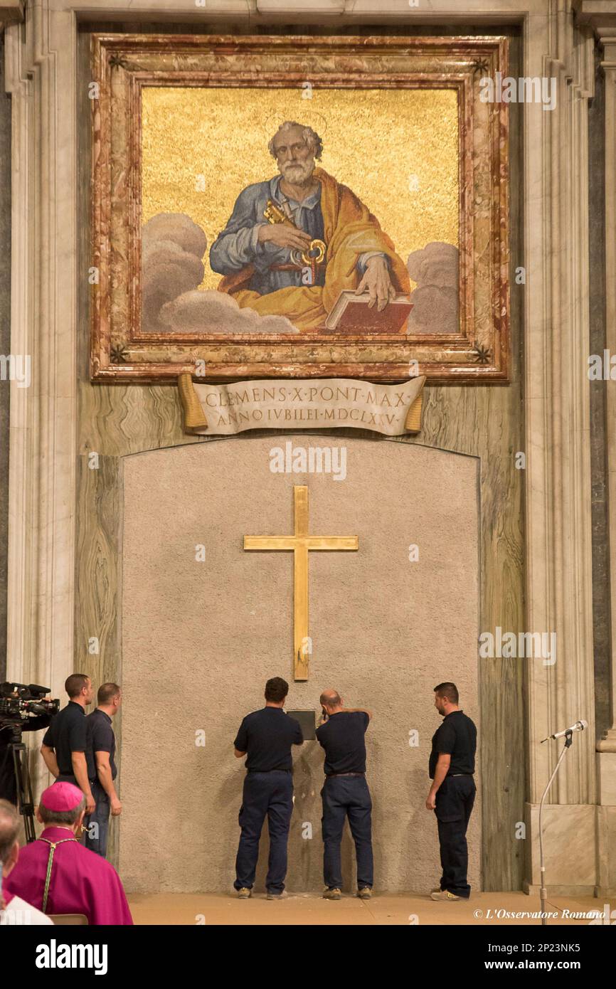 Workers break the brick wall which has hidden the Holy Door at St ...