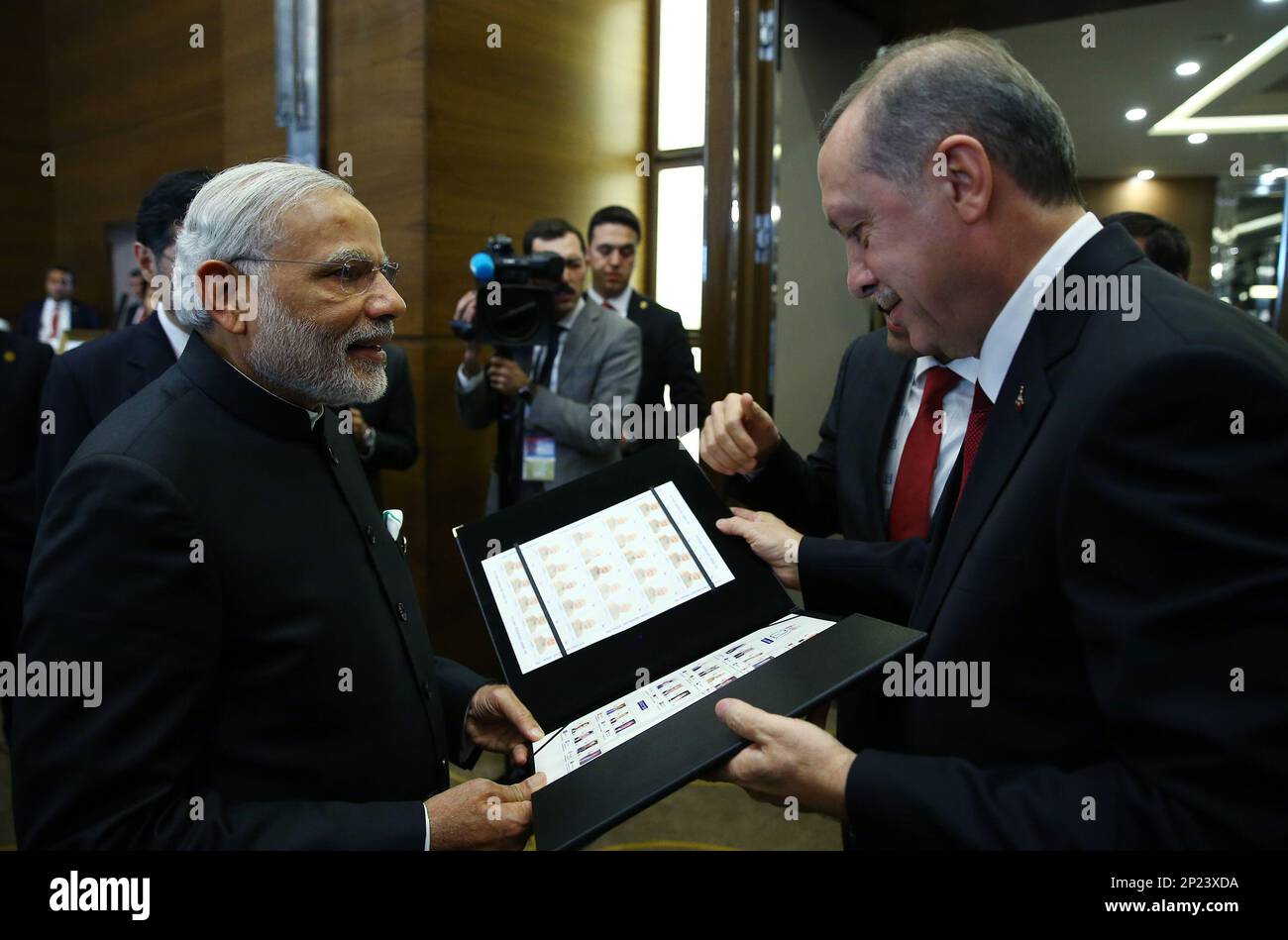 Turkish President Recep Tayyip Erdogan, right, presents a photo album ...