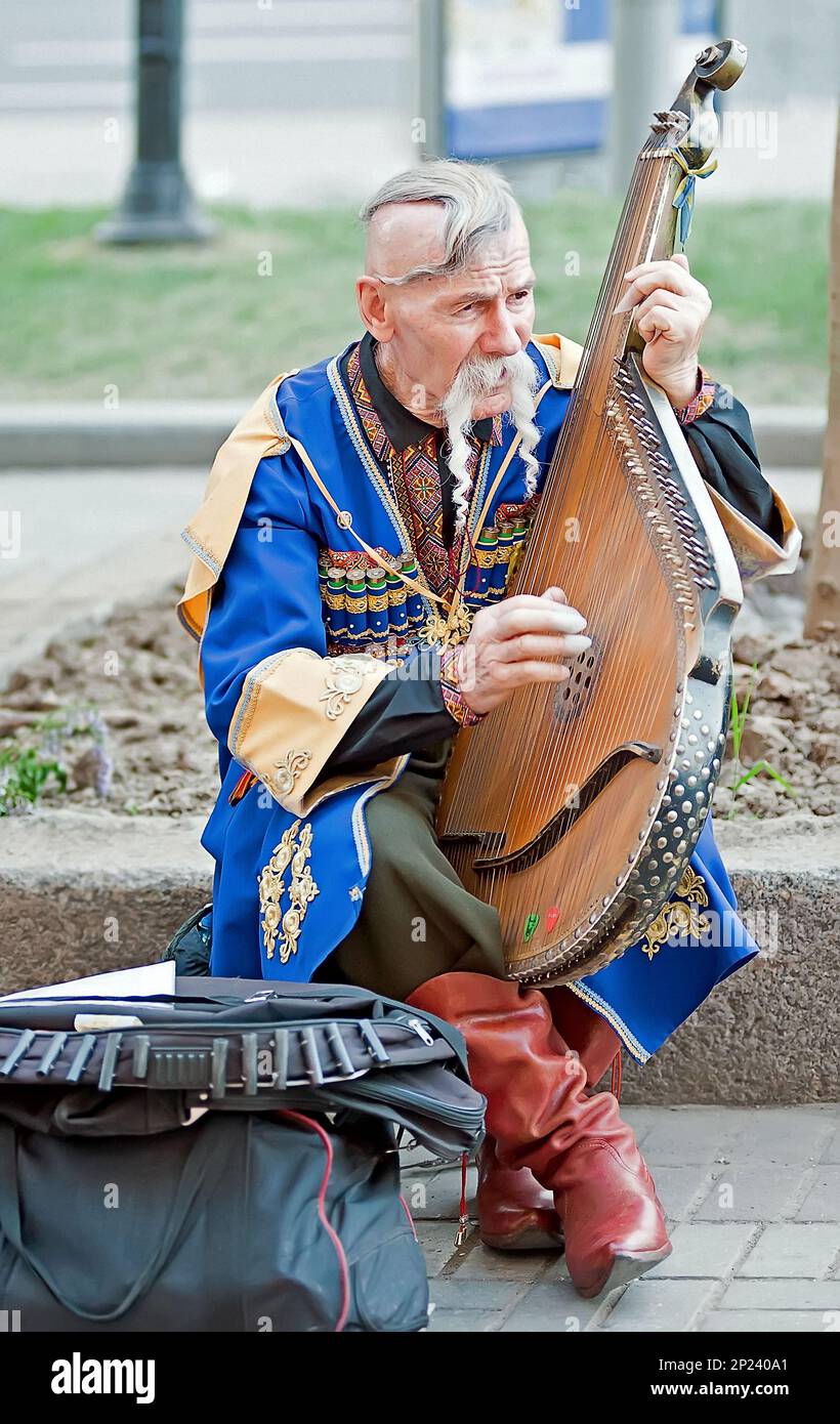 An Kobzar singing to his own accompaniment on bandura instrument on ...