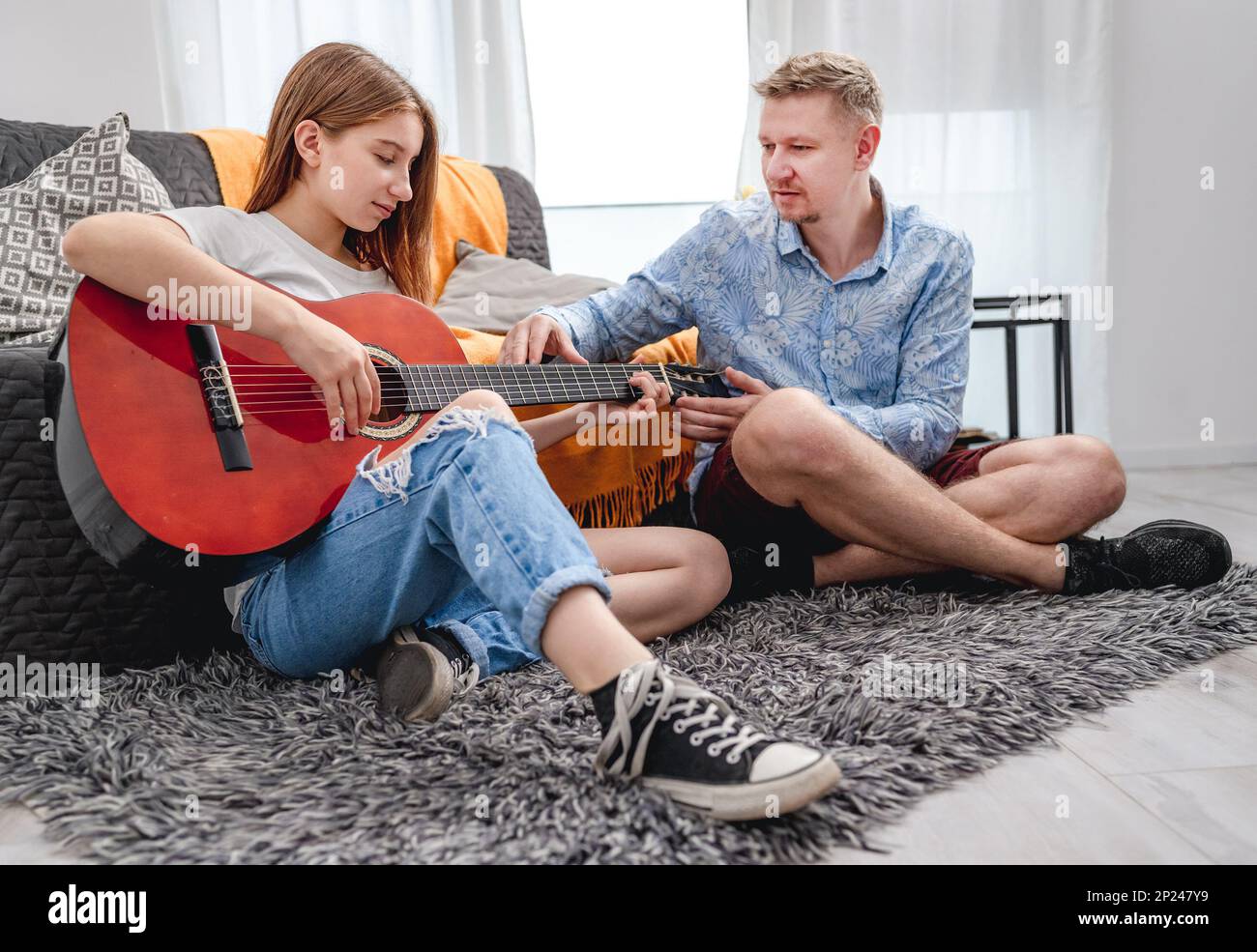 Girl teenager practicing guitar playing Stock Photo - Alamy
