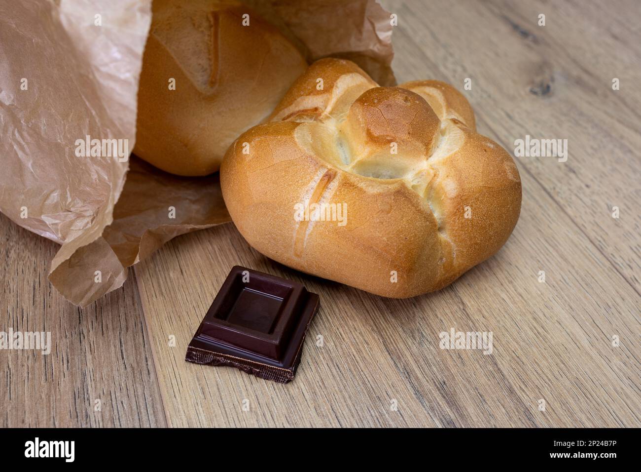 ypical Milan tradition bread "michetta" with dark chocolate square on ...