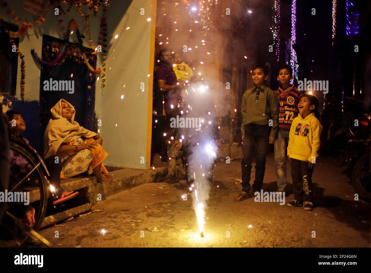 Indians watch a firecracker light up during Diwali celebrations in New ...
