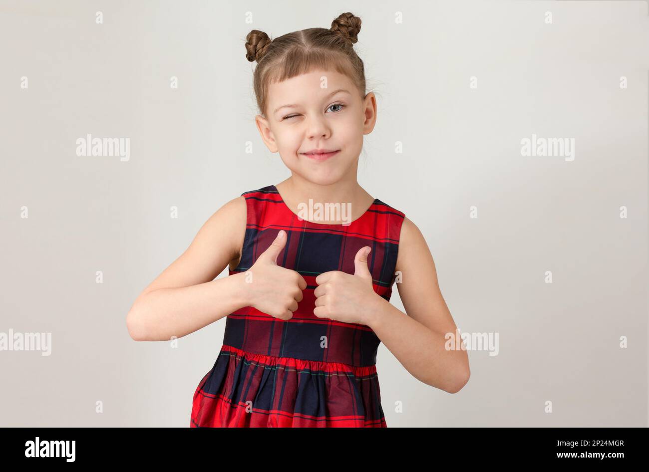Cute winking child little girl kid with thumbs up on both hands of 6 7 ...