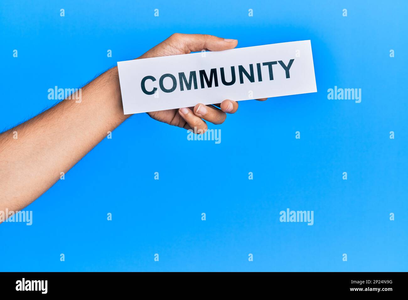 Hand of caucasian man holding paper with community word over isolated ...