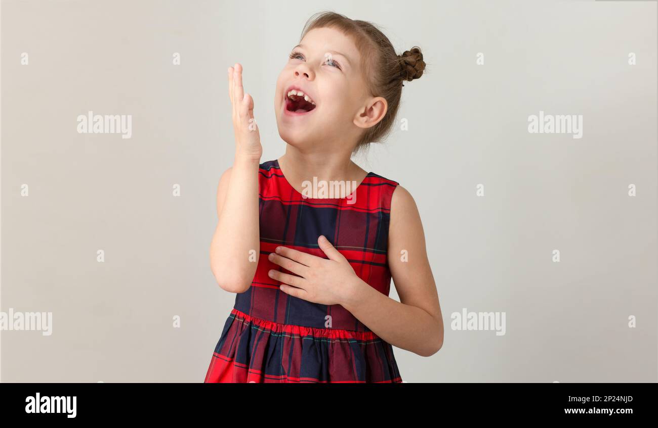 Laughing and admiring with wide open mouth child looking up with raised ...