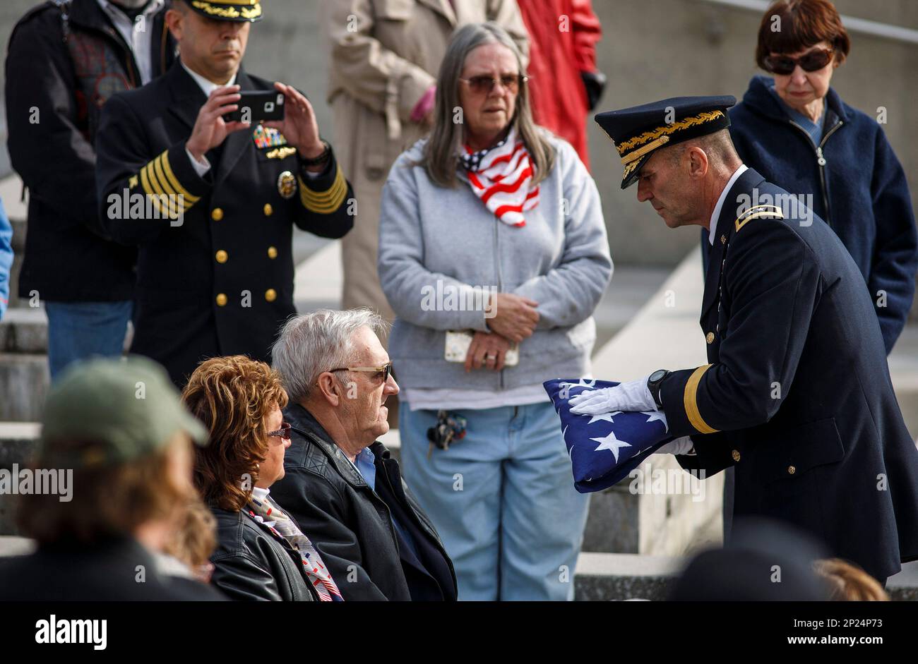 Richard Bohner, seated left, receives the flag as his uncle, Cpl ...