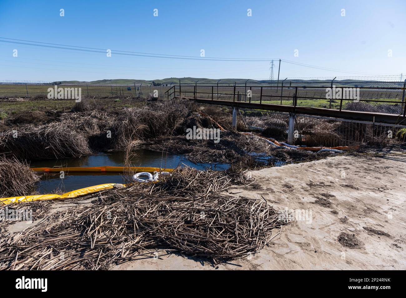 Containment booms and absorbents float in outfall #1 along Union Creek ...