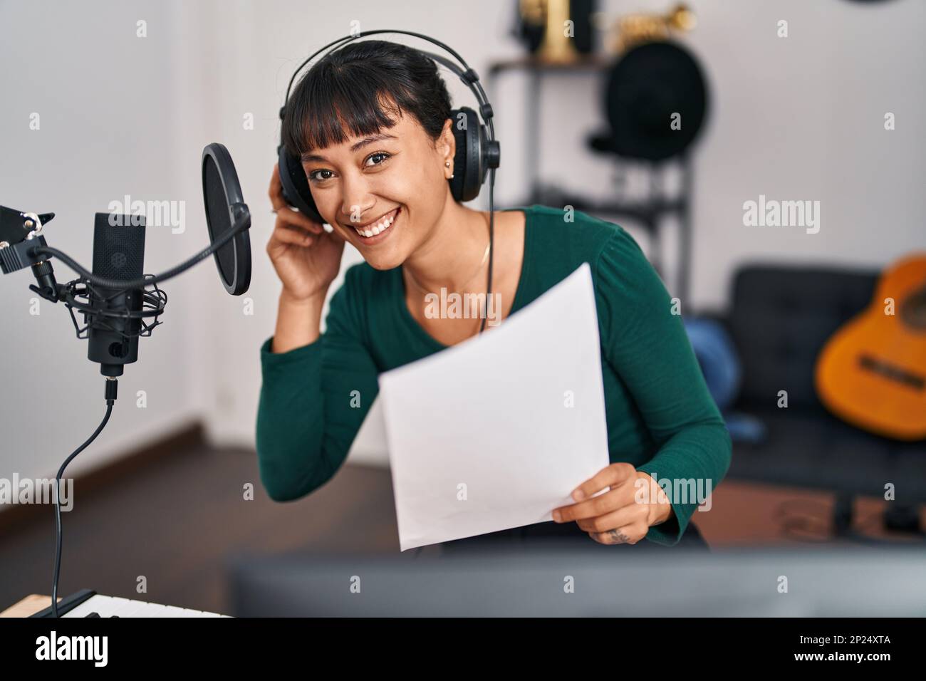 Young beautiful hispanic woman musician smiling confident singing song ...