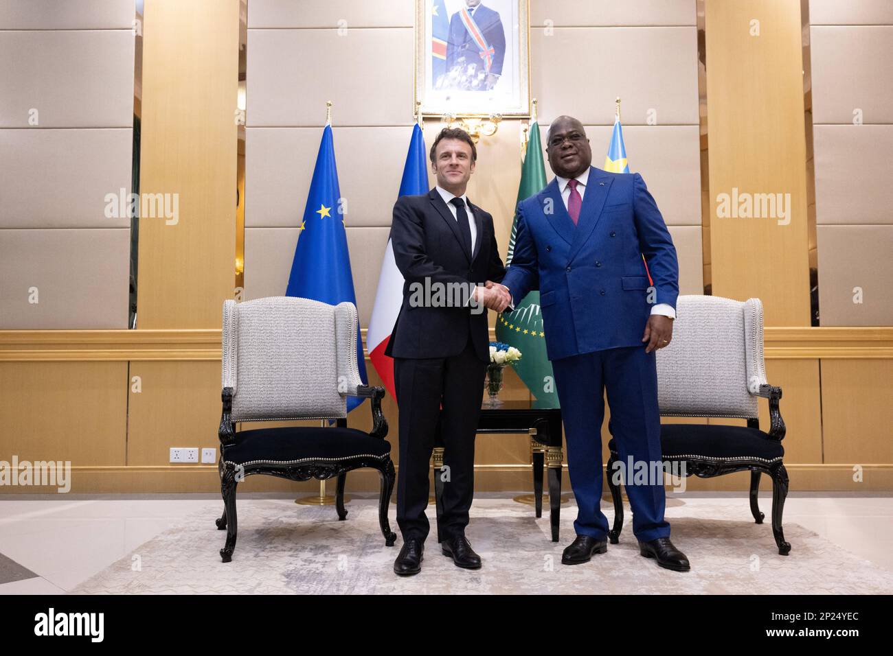 France's President Emmanuel Macron shakes hands with Democratic ...