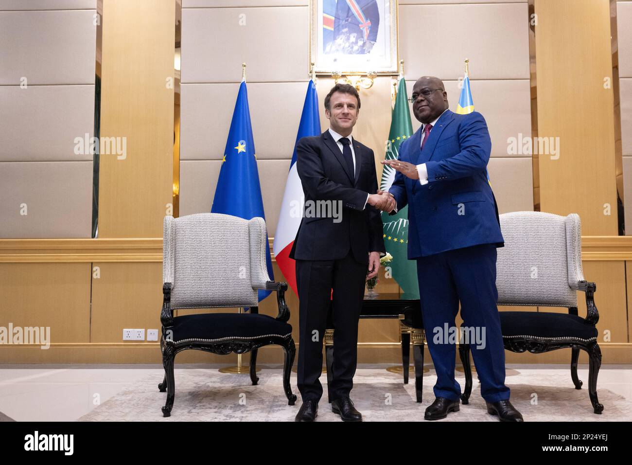 France's President Emmanuel Macron shakes hands with Democratic ...