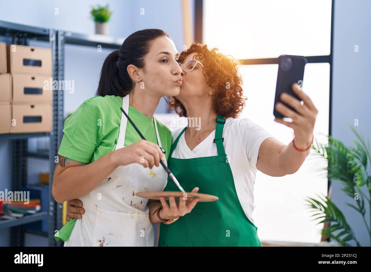 Two women artists make selfie by smartphone drawing at art studio Stock ...