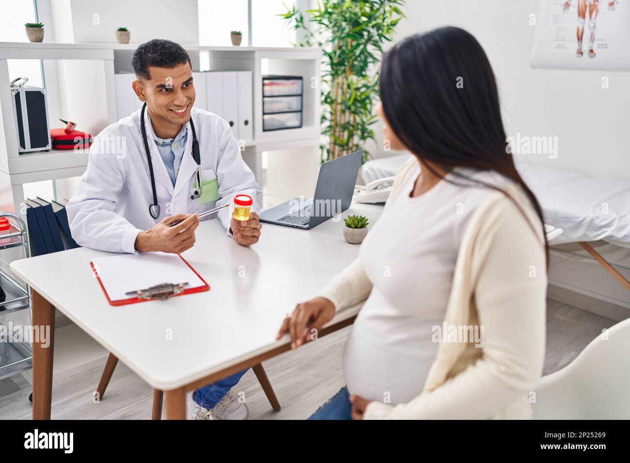 Young latin couple doctor and patient having medical session holding ...