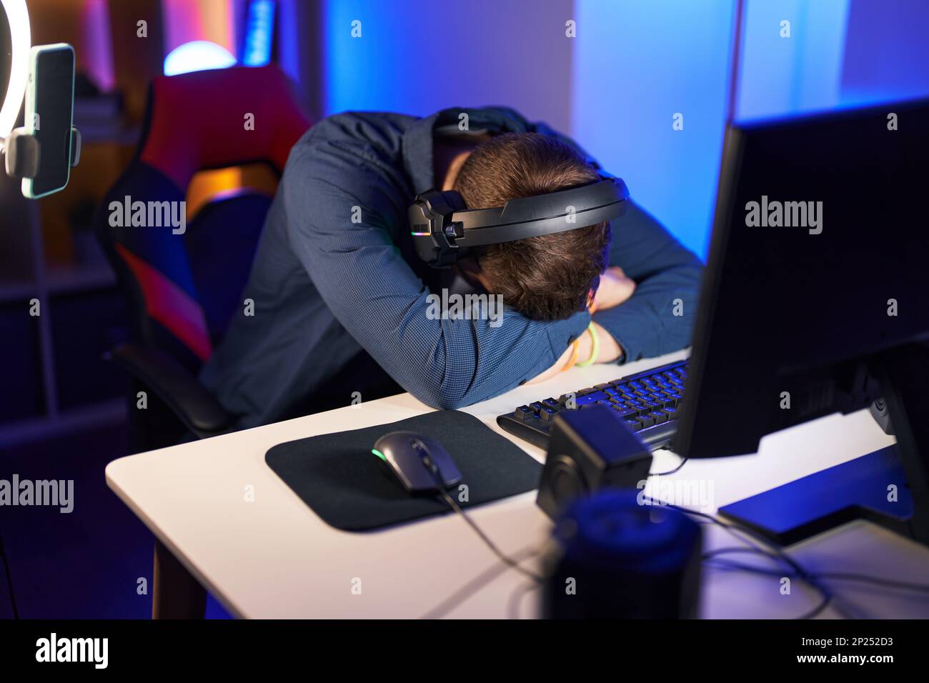 Young caucasian man streamer stressed using computer at gaming room ...