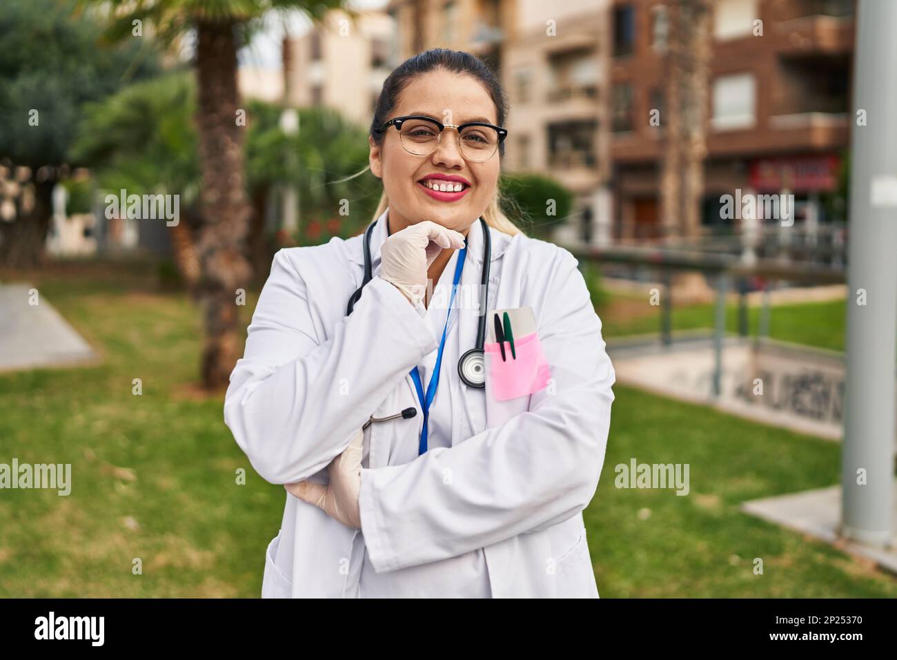 Young beautiful plus size woman doctor smiling confident standing with ...