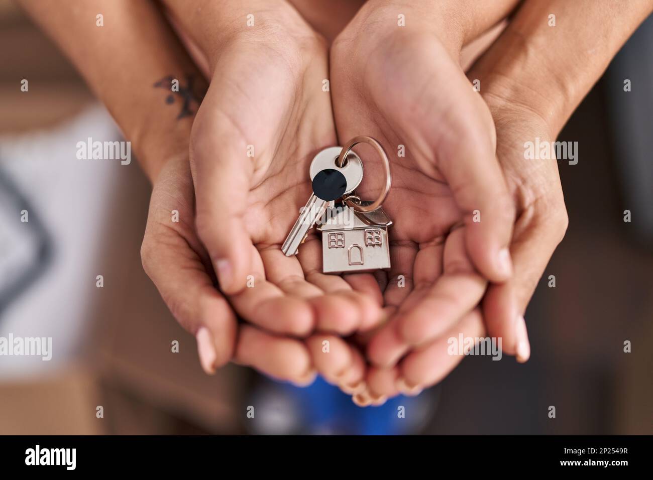 Woman and girl mother and daughter hands holding key at new home Stock ...