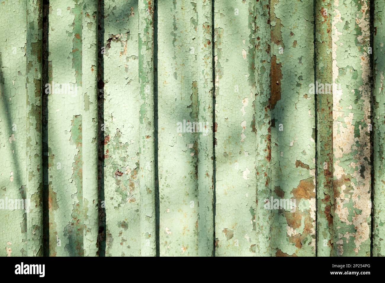 Sea green color old cracked wall background. Painted metal fence with ...