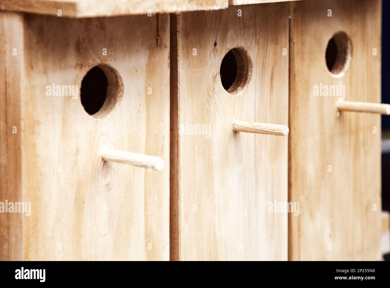Several wooden birdhouses in a row background. A few wood bird houses ...