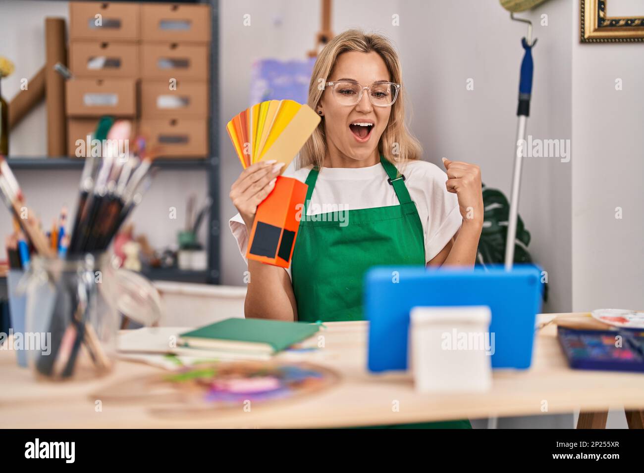 Young caucasian woman doing video call showing color palette screaming ...