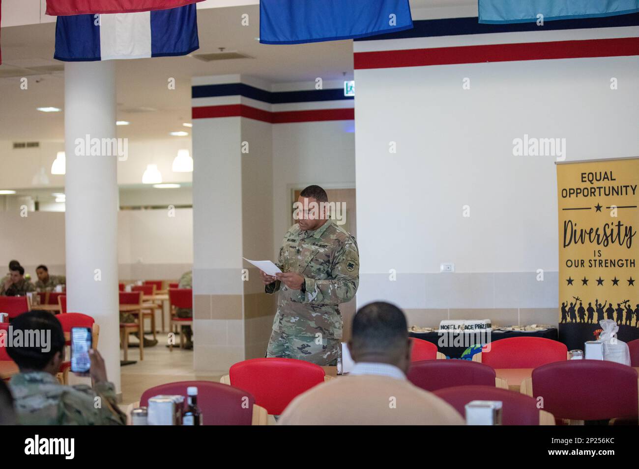 Headquarters Support Company First Sgt. James Williams reads an excerpt ...