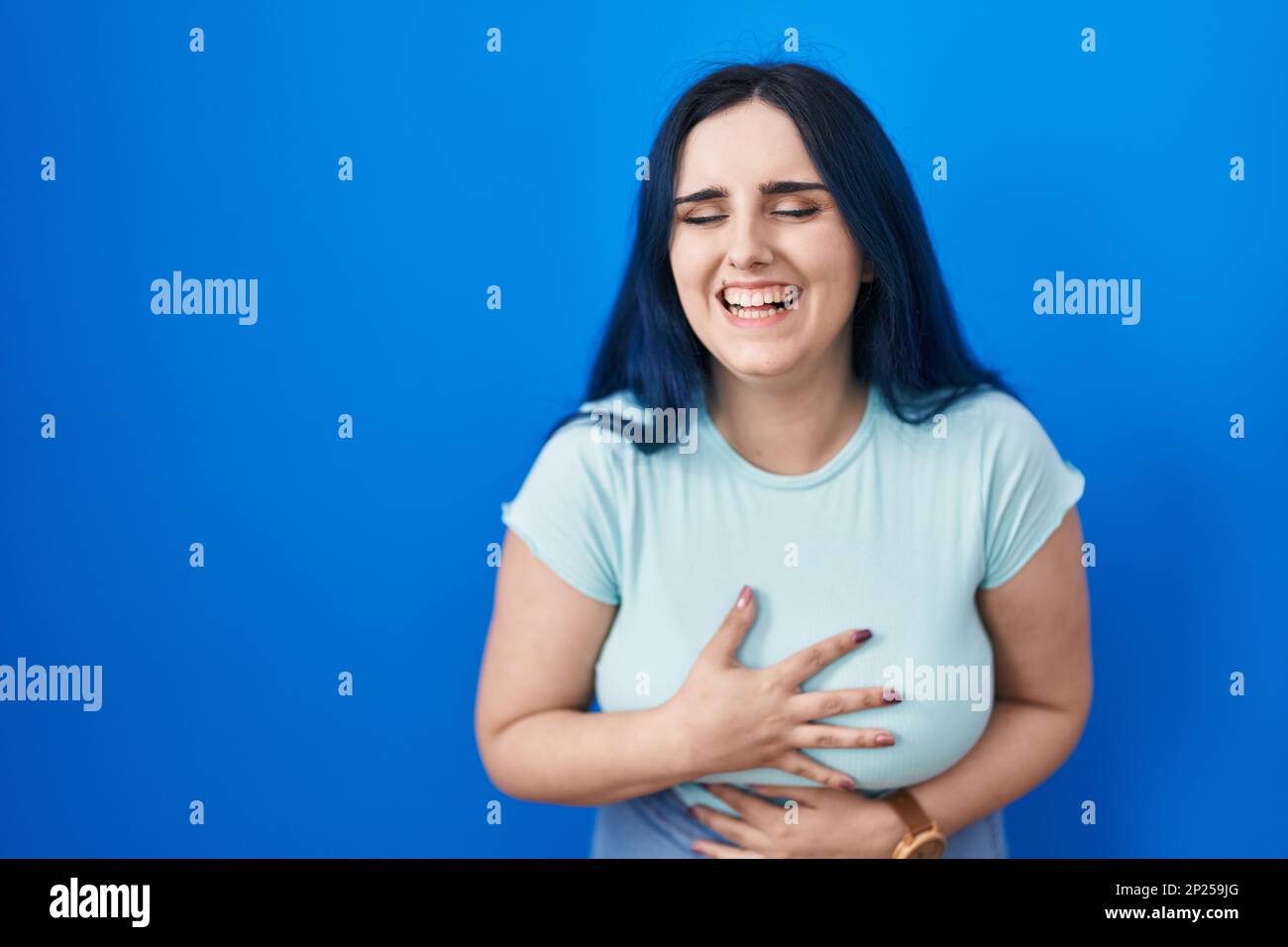 Young Modern Girl With Blue Hair Standing Over Blue Background Smiling 7177