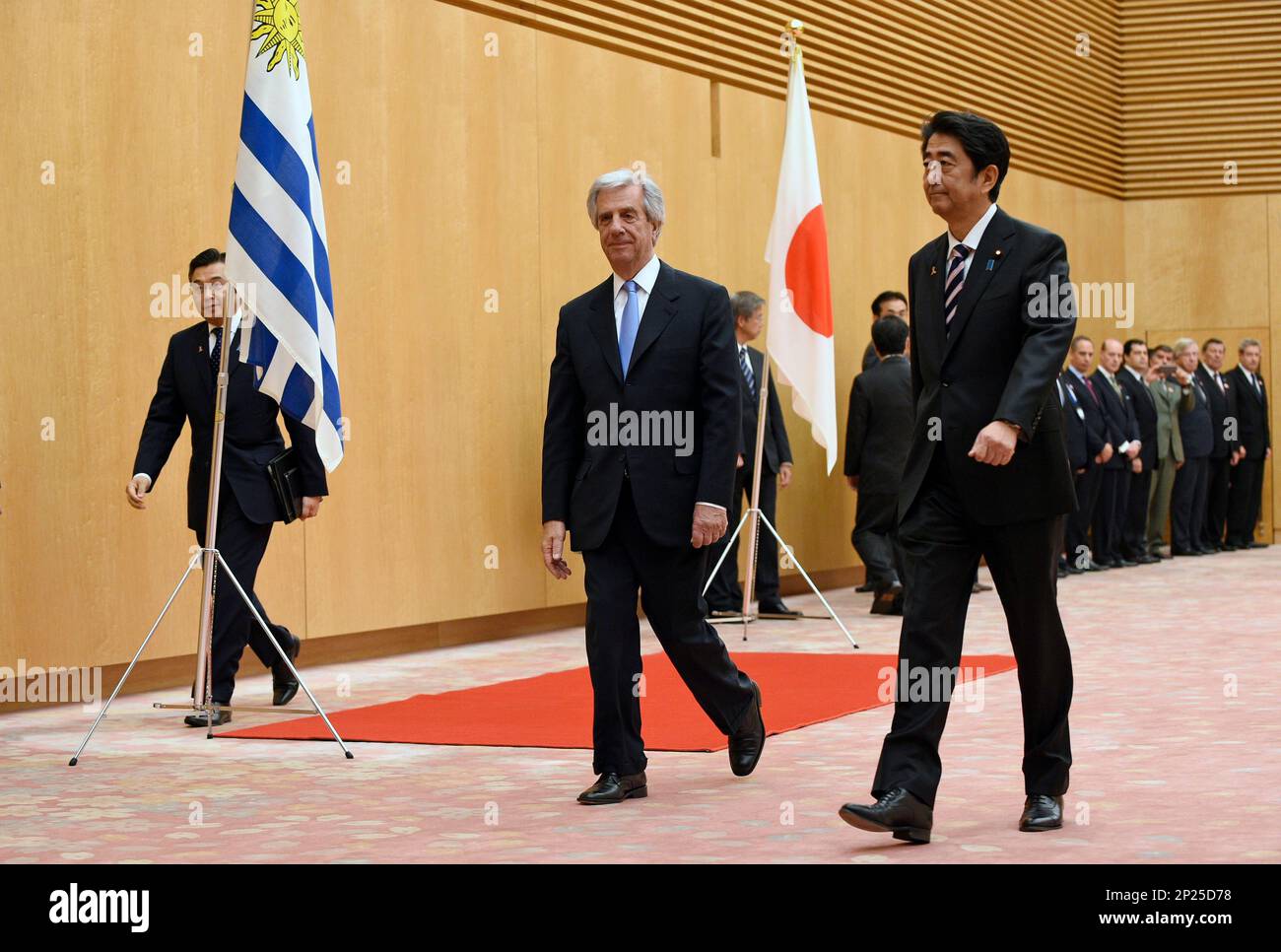 Uruguayan President Tabare Vazquez, center, is escorted by Japanese Prime Minister Shinzo Abe ...