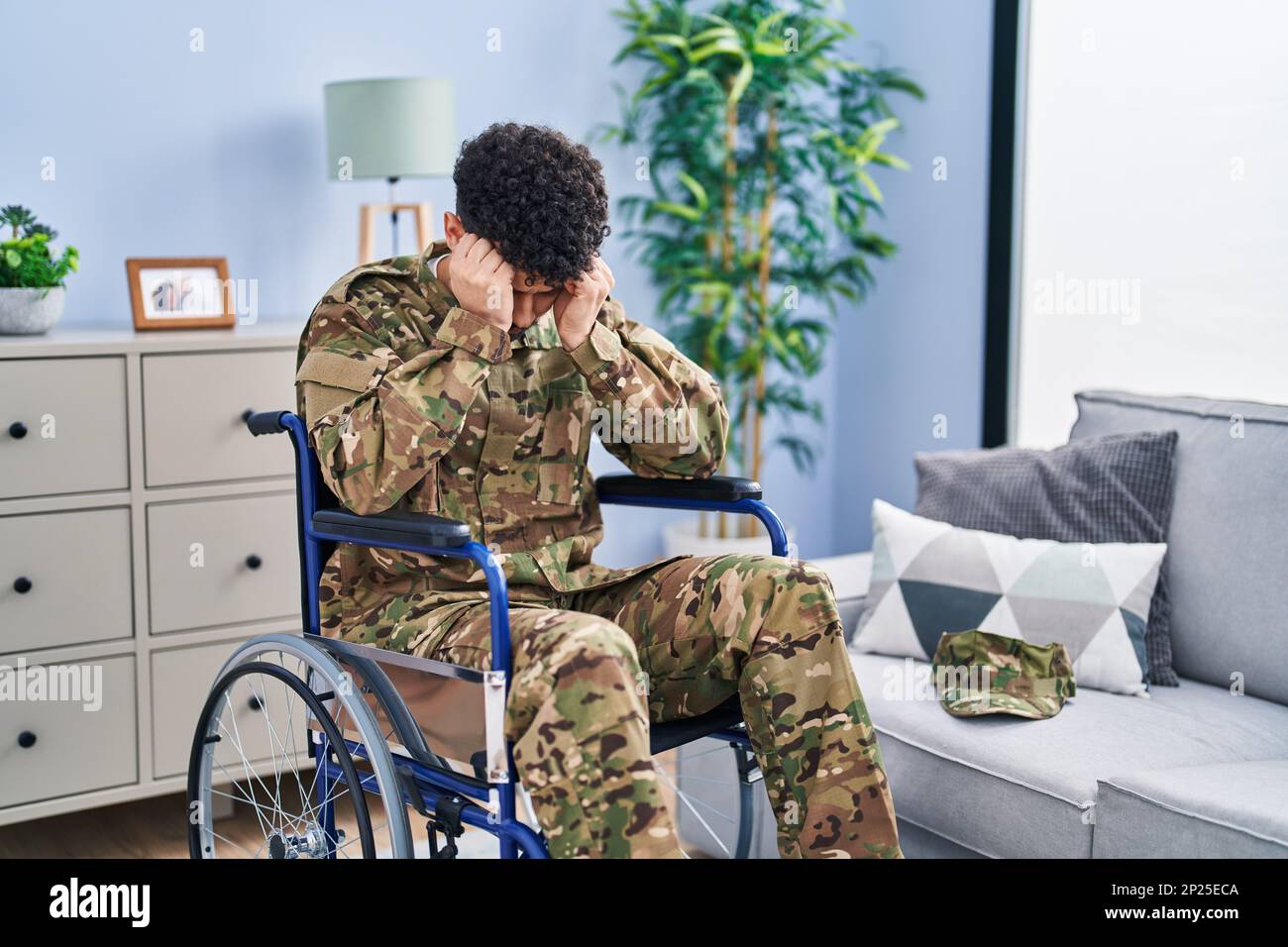 Arab man wearing camouflage army uniform sitting on wheelchair ...