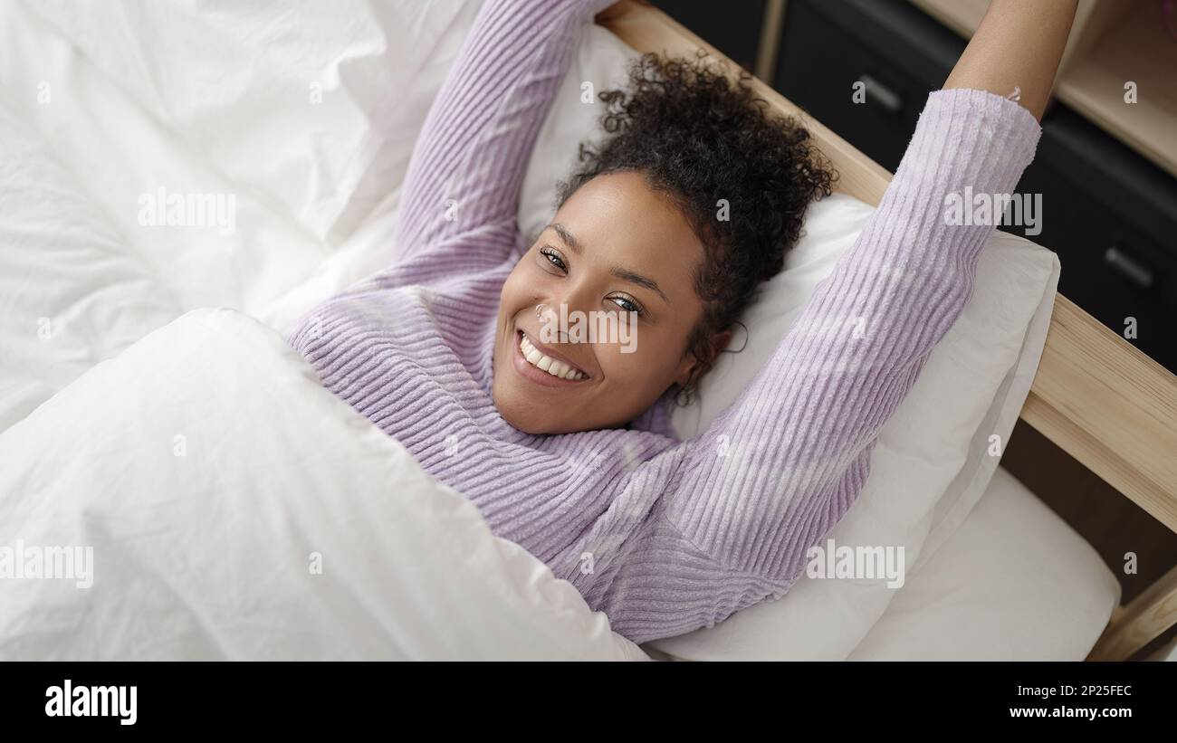 African american woman waking up stretching arms hi-res stock ...