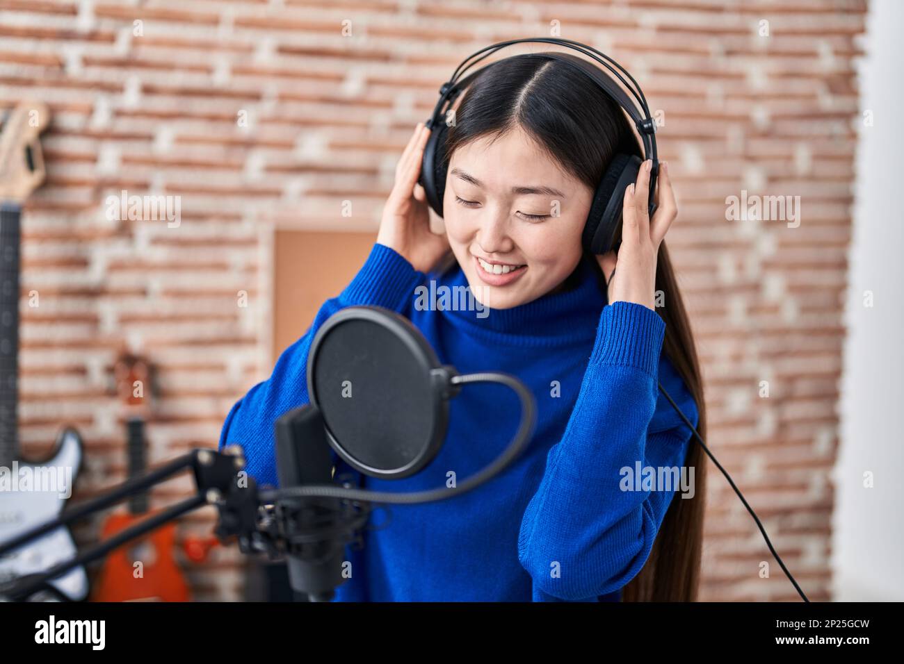 Chinese woman artist singing song at music studio Stock Photo - Alamy