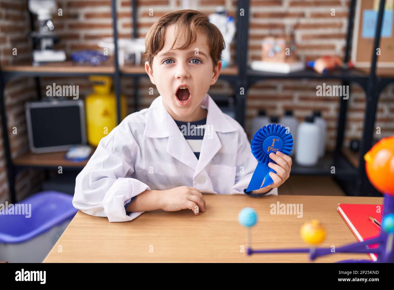 Little caucasian boy at school scientist laboratory winning first prize ...