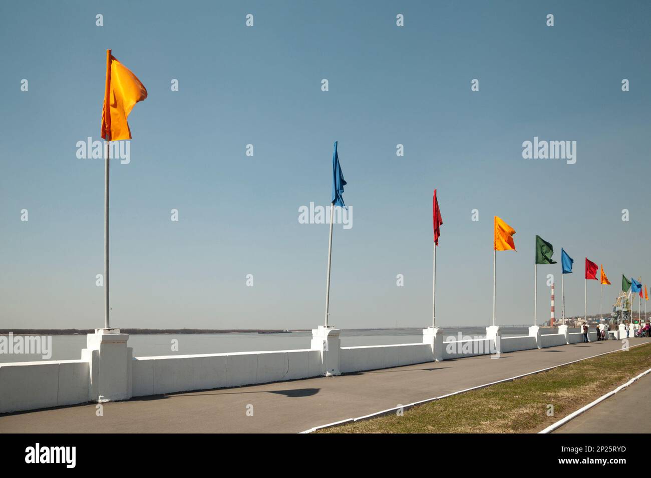 Row of colorful festive flags in a public park along the waterfront ...