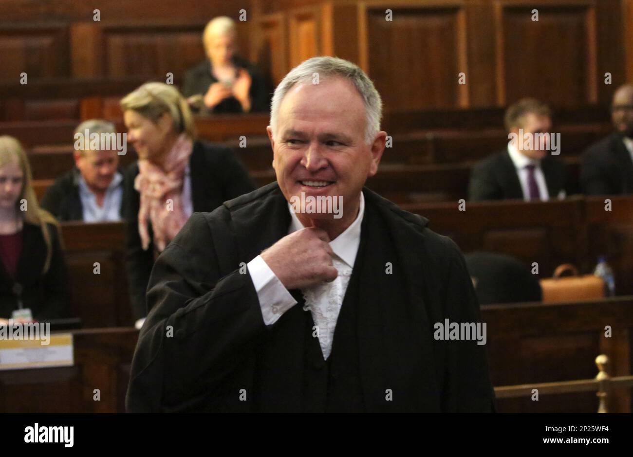 Defence lawyer Barry Roux smiles as he waits before the hearing gets ...